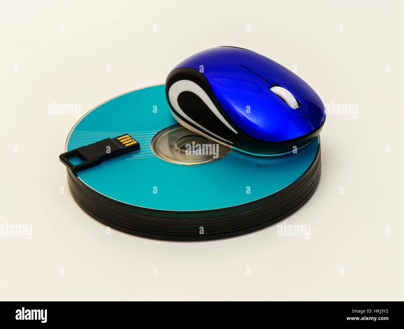 On a white background is a stack of CD / DVD disk with a computer mouse ...