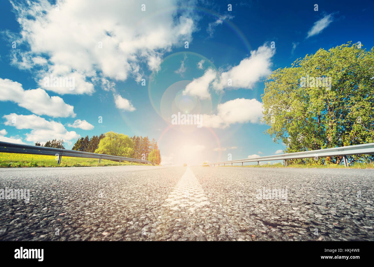 Car on asphalt road in beautiful spring day Stock Photo - Alamy