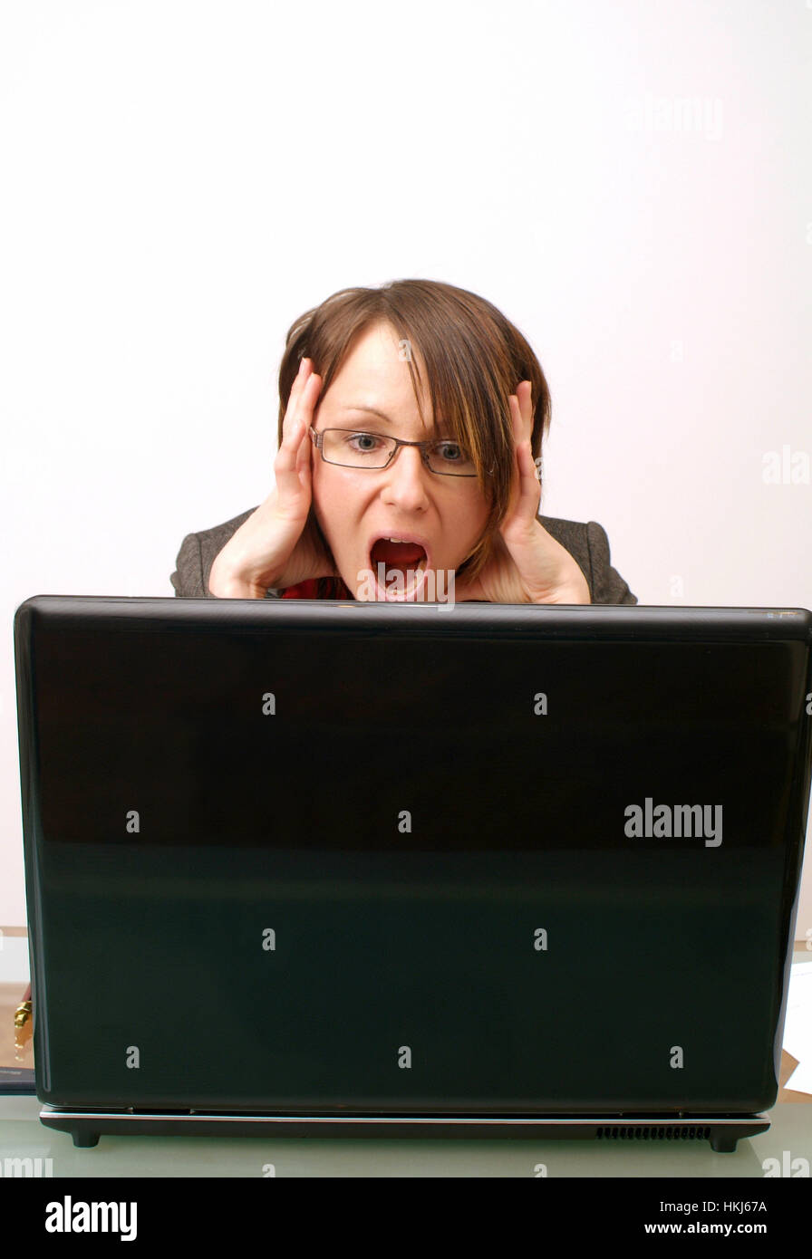 Young business woman in panic using laptop Stock Photo - Alamy
