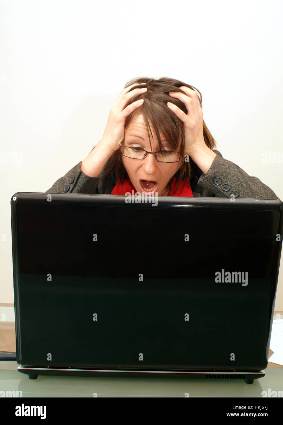 Young business woman in panic using laptop Stock Photo - Alamy