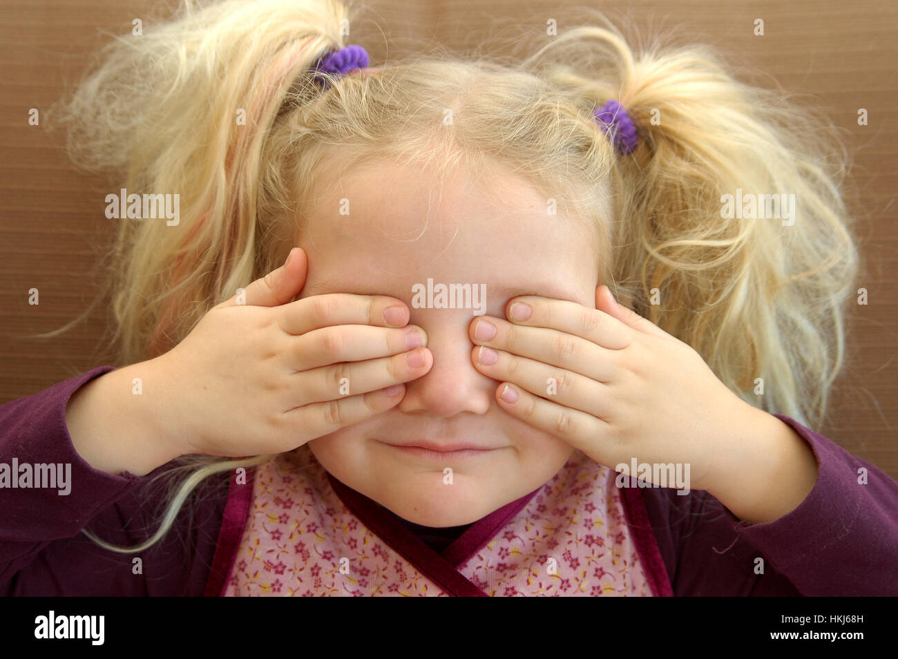 Girl keeps eyes shut Stock Photo - Alamy