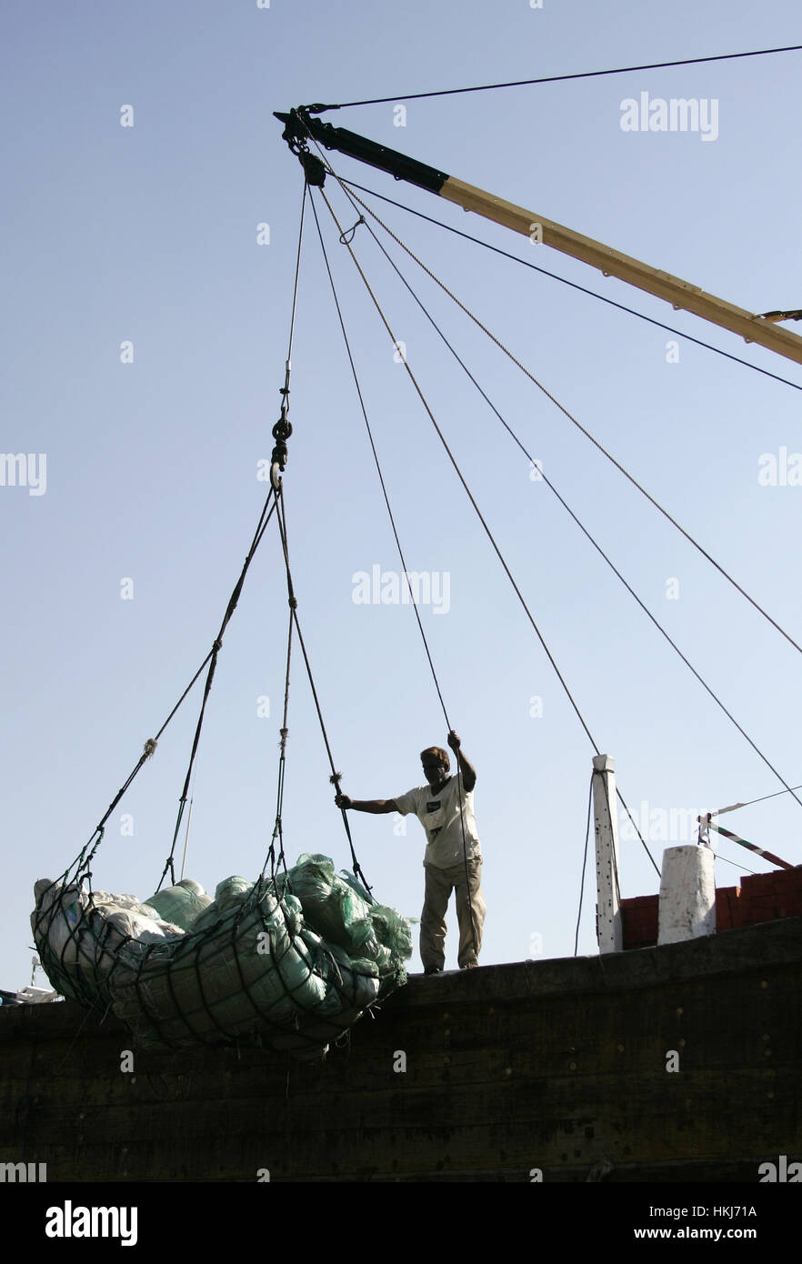 Worker loading a ship, Dubai, United Arab Emirates Stock Photo - Alamy