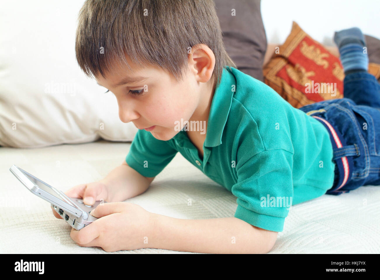 Boy playing with Gameboy Stock Photo - Alamy