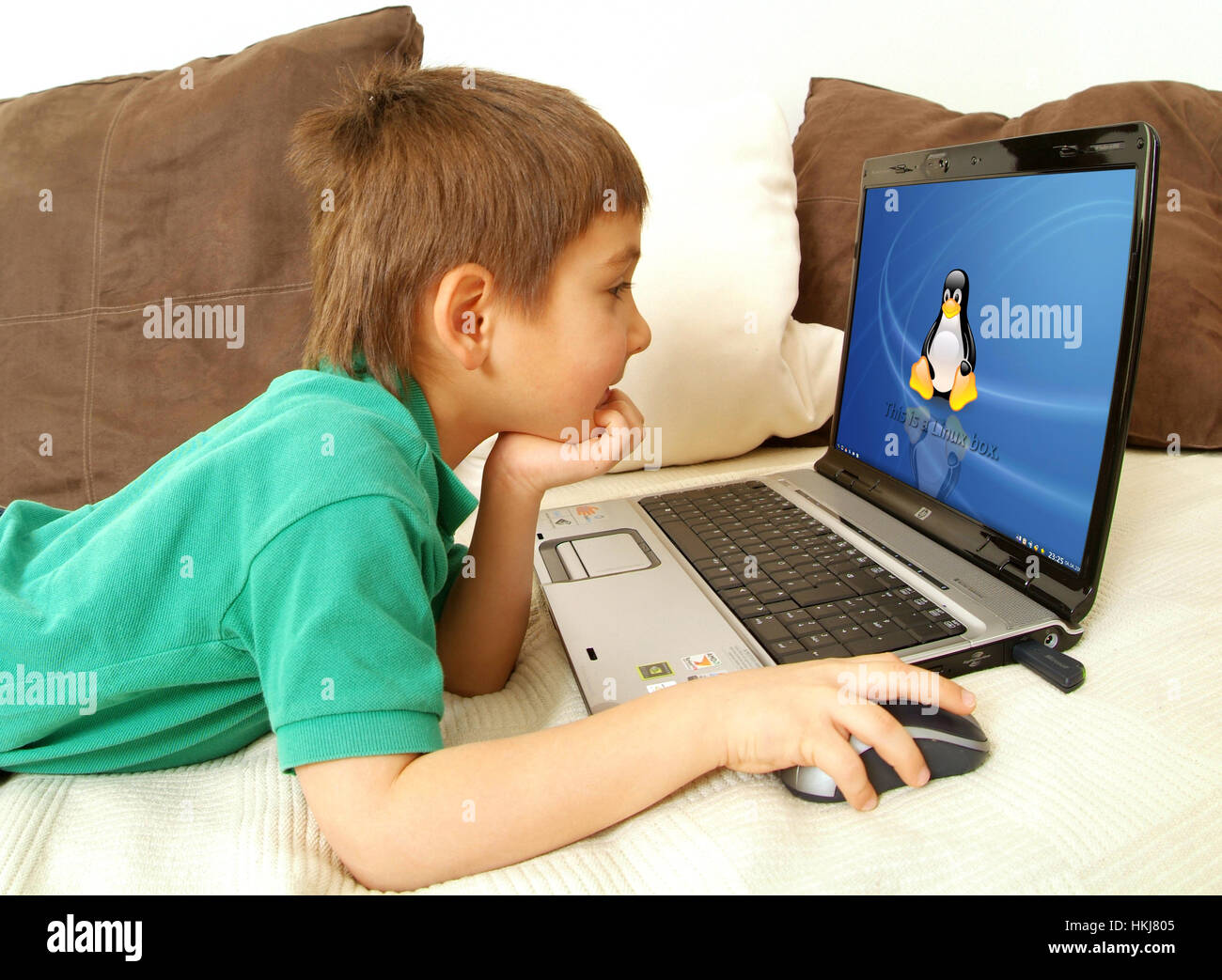 Boy using laptop with linux operating system Stock Photo - Alamy