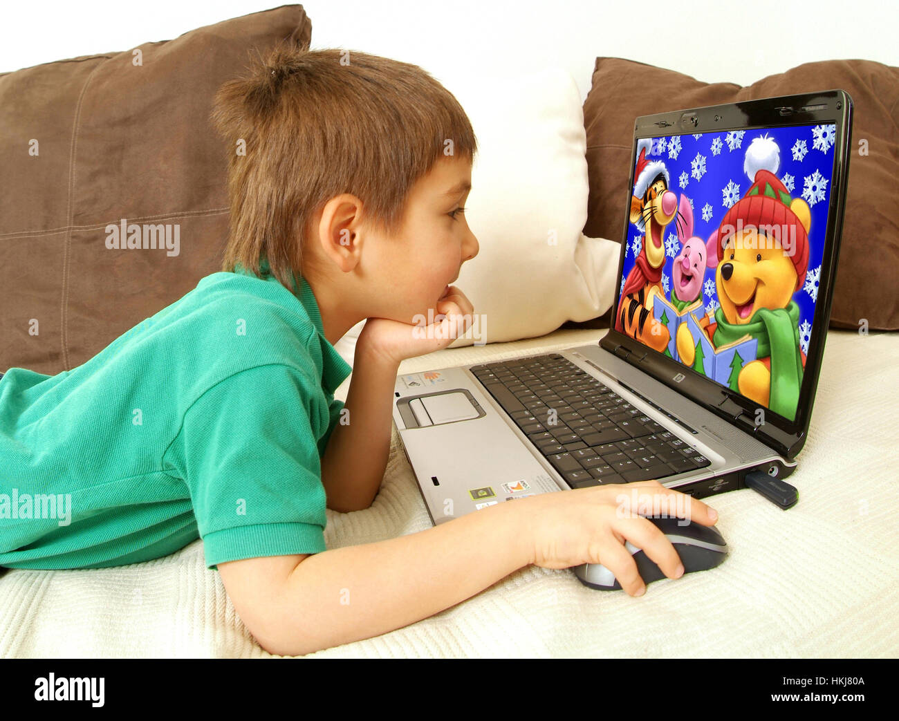 Boy with laptop with funny Christmas desktop Stock Photo - Alamy