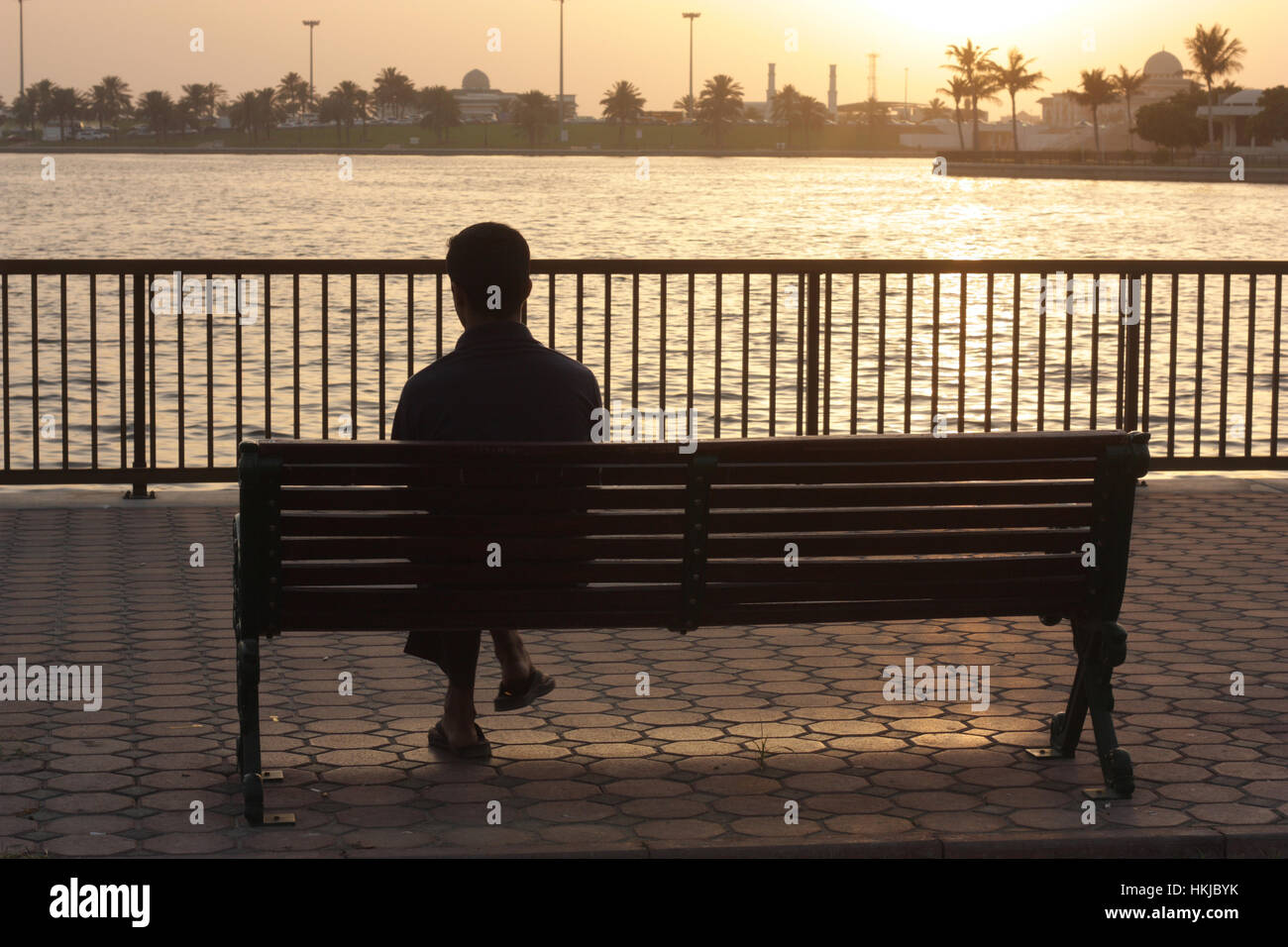 Silhouette of Alone man setting on bench Stock Photo - Alamy