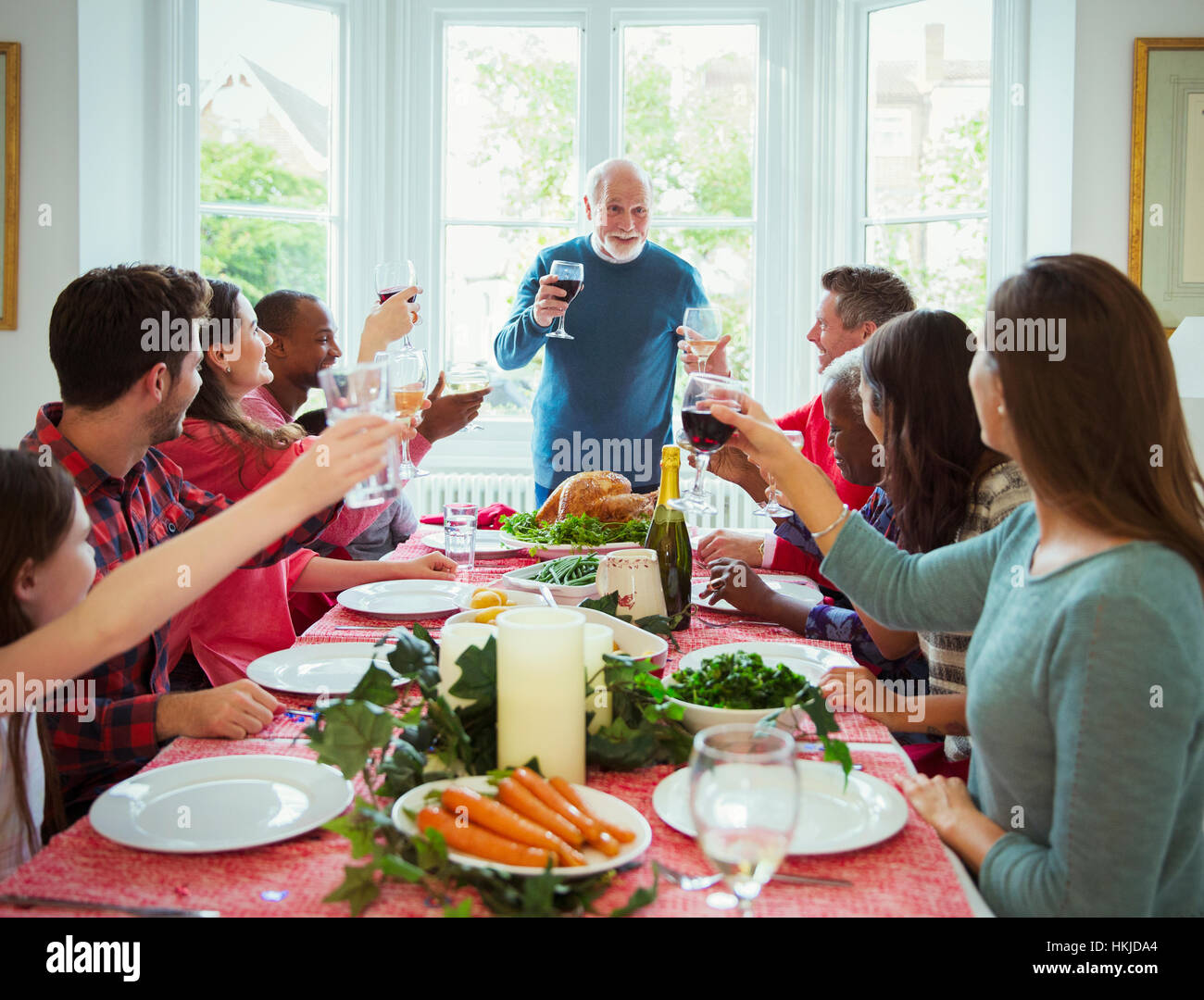 Grandfather making toast with wine at Christmas dinner table Stock ...
