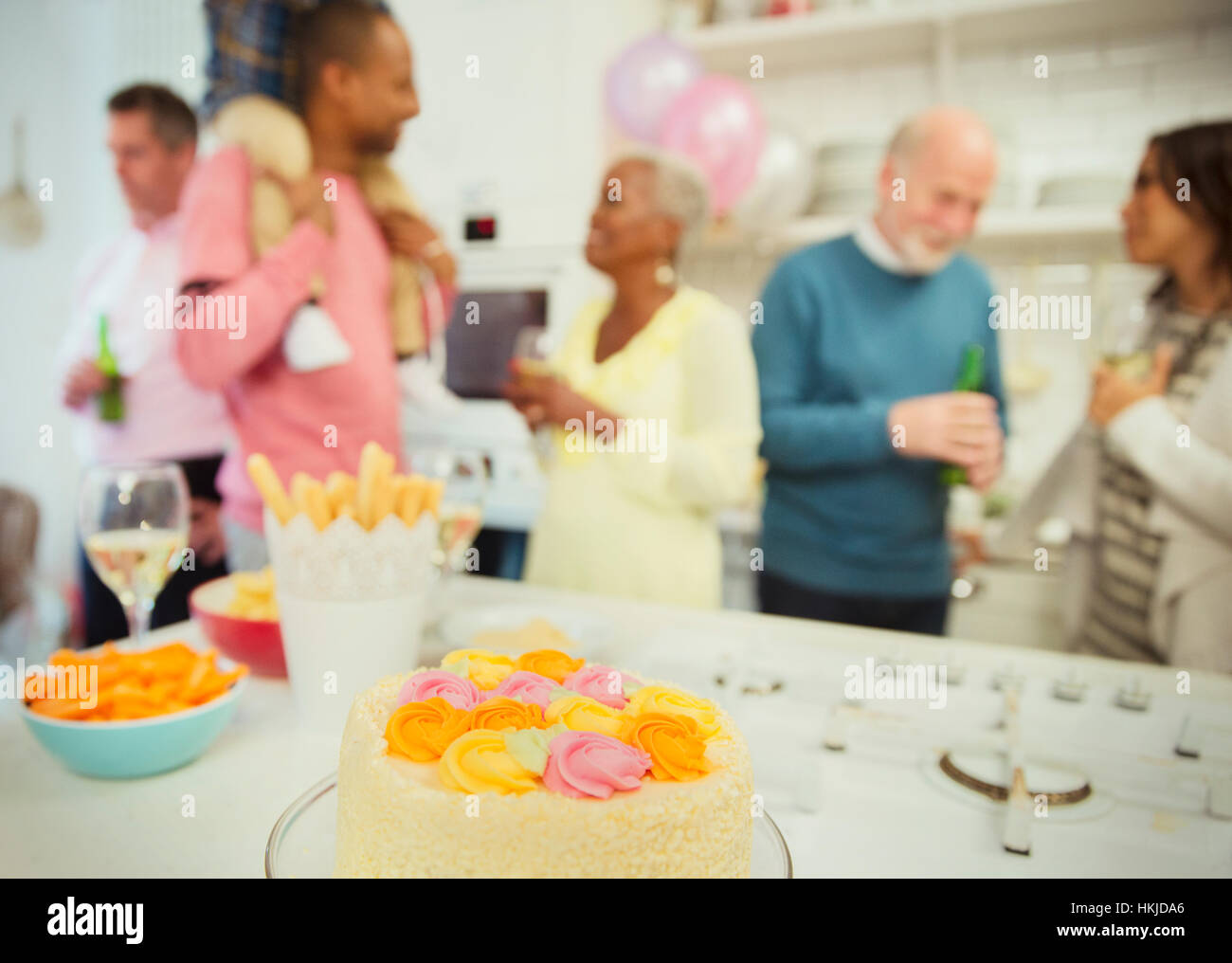 Family enjoying party behind cake Stock Photo - Alamy
