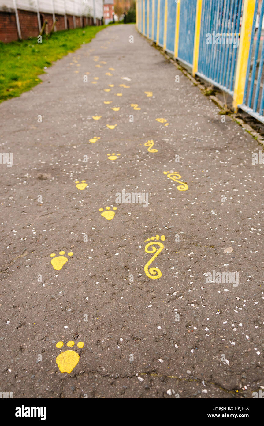 Painted footsteps on an inner city footpath Stock Photo - Alamy