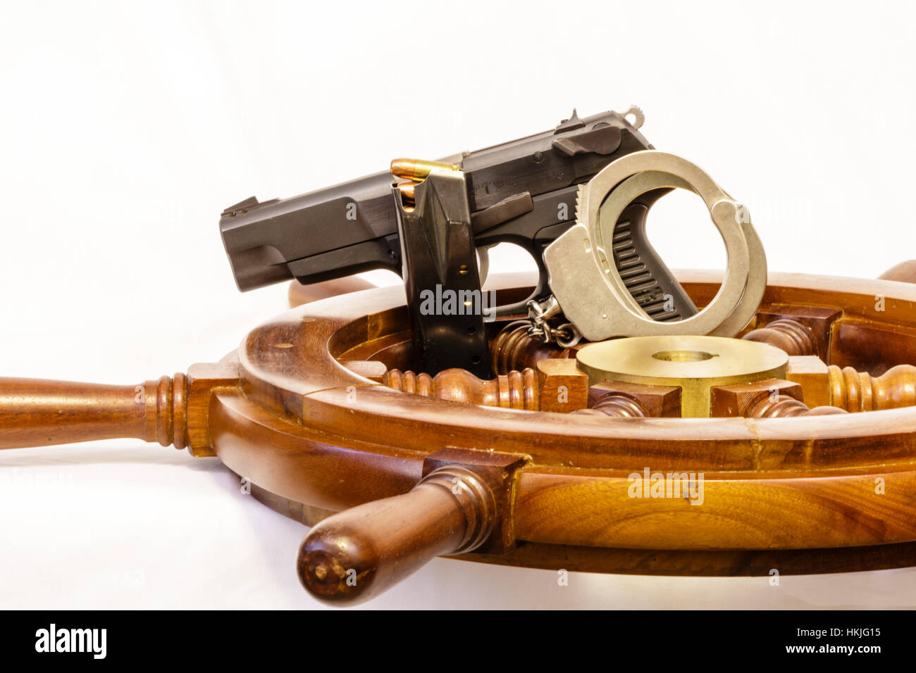Ships wheel, gun, cuffs and clip with a white background Stock Photo ...