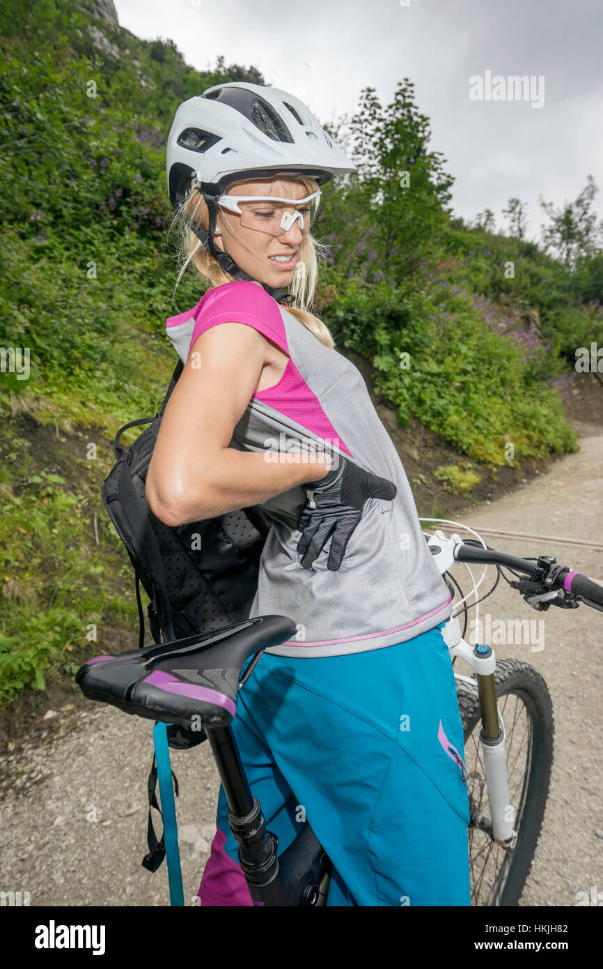 Mountainbiker with pain in back, Kampenwand, Bavaria, Germany Stock ...