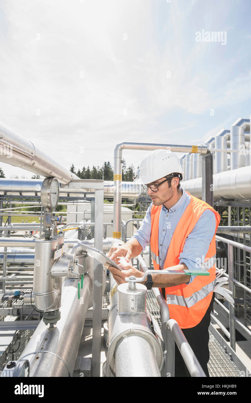 Male engineer controlling measuring instrument at geothermal power ...