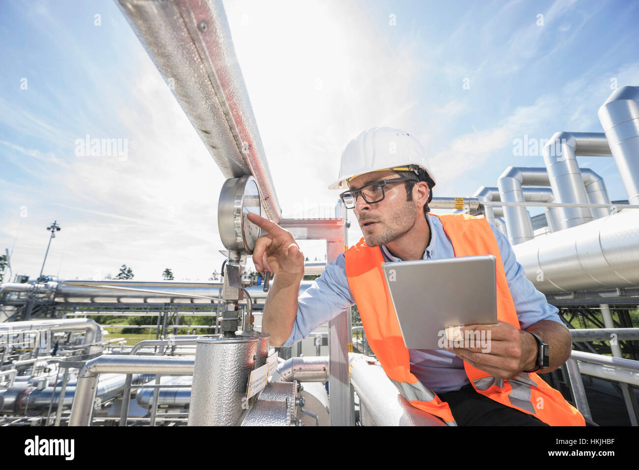 Male engineer controlling measuring instrument at geothermal power ...