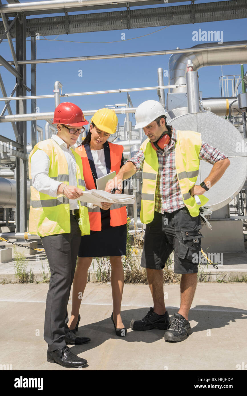 Engineer with his colleagues in meeting at geothermal power station ...