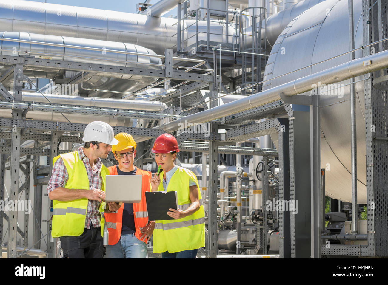 Engineer with his colleagues in meeting with laptop at geothermal power ...