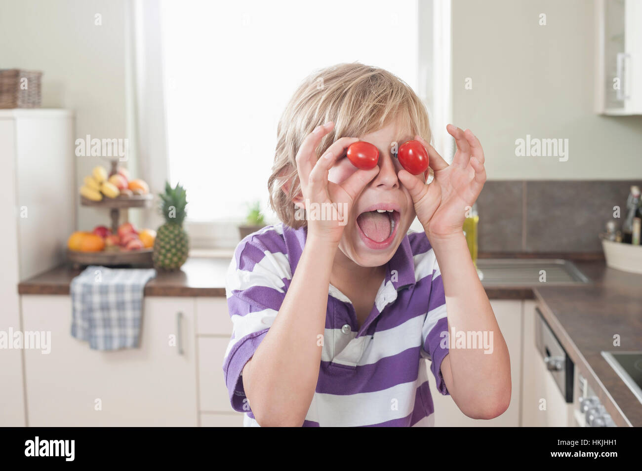 Child making funny face eating hi-res stock photography and images - Alamy