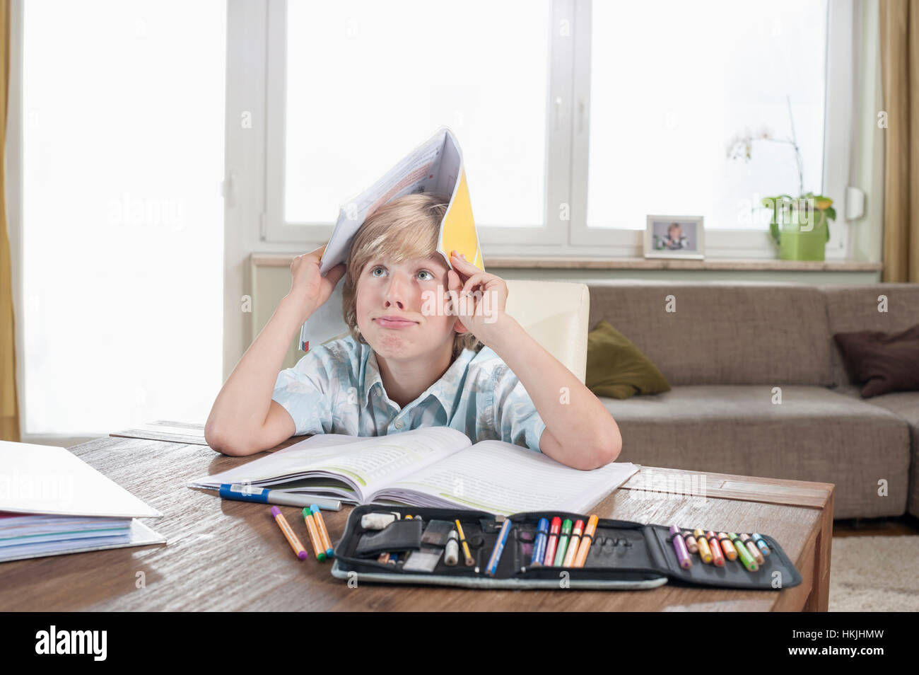 Bored boy with open book on head,Bavaria,Germany Stock Photo - Alamy