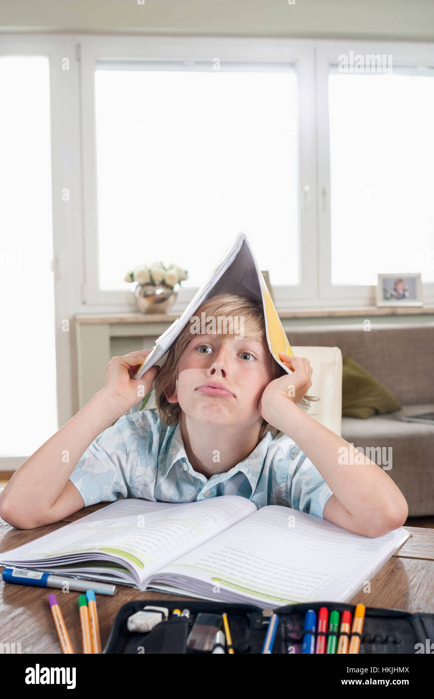 Bored boy with open book on head,Bavaria,Germany Stock Photo - Alamy