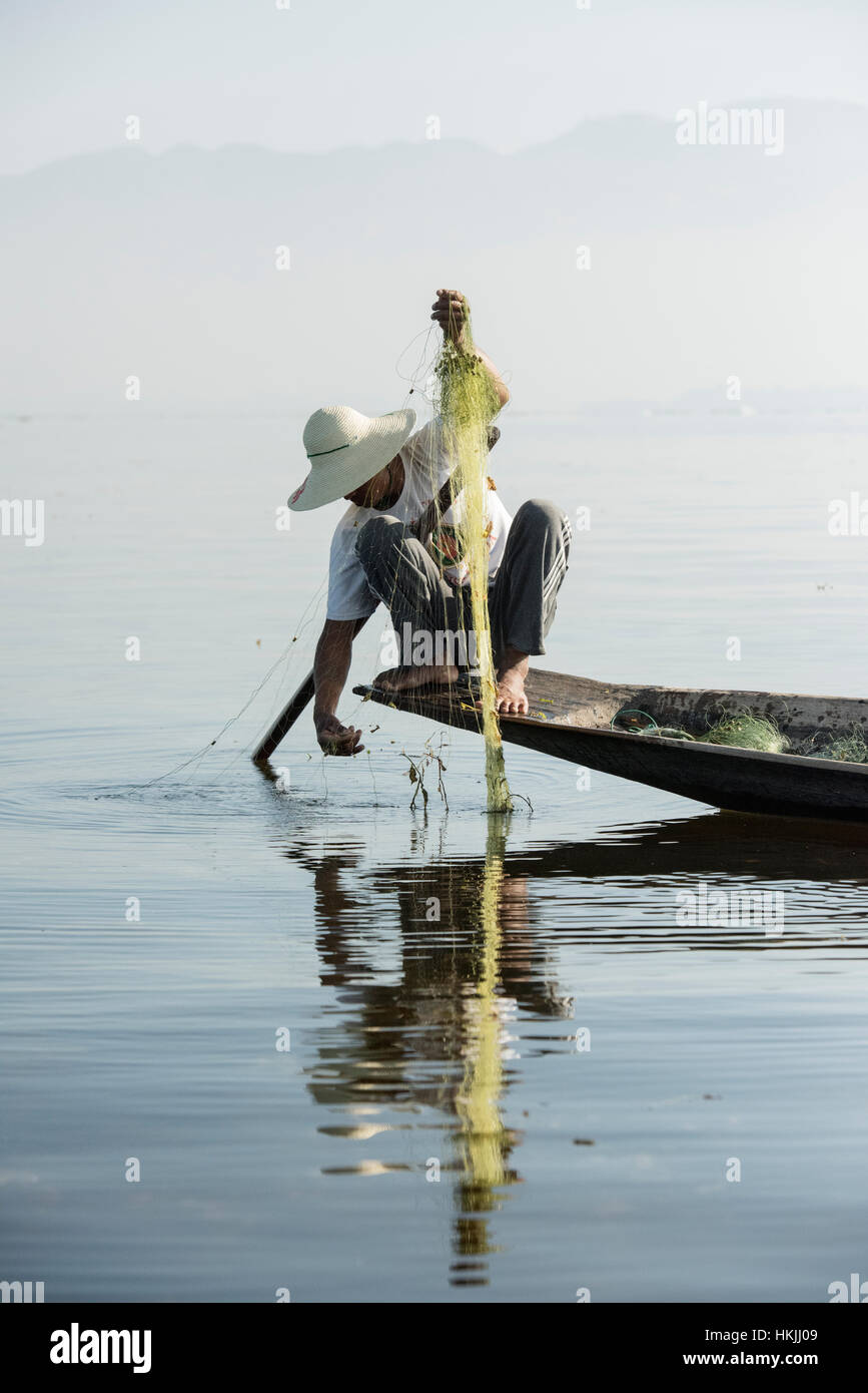 A fisherman from the Intha tribe fishing on Lake Inle in the Shan State ...
