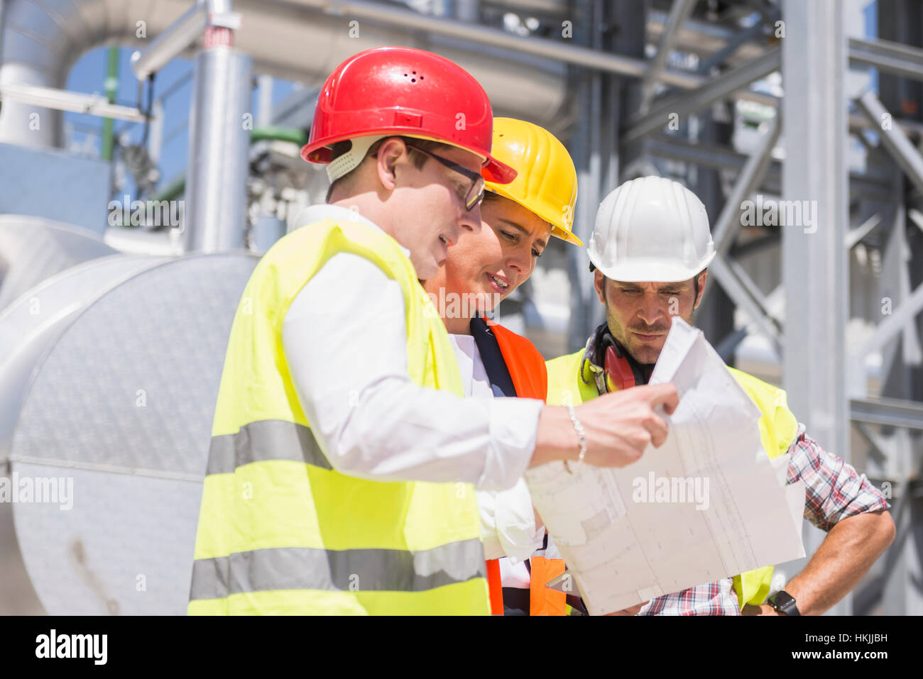 Engineer and workers in meeting on the area of a geothermal power ...