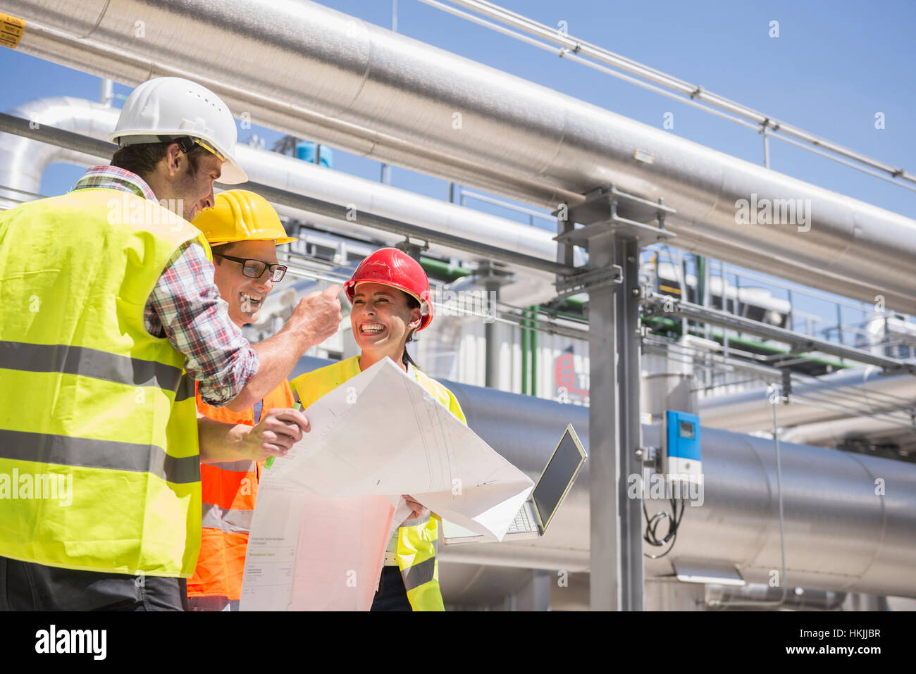 Engineer and workers in meeting on the area of a geothermal power ...