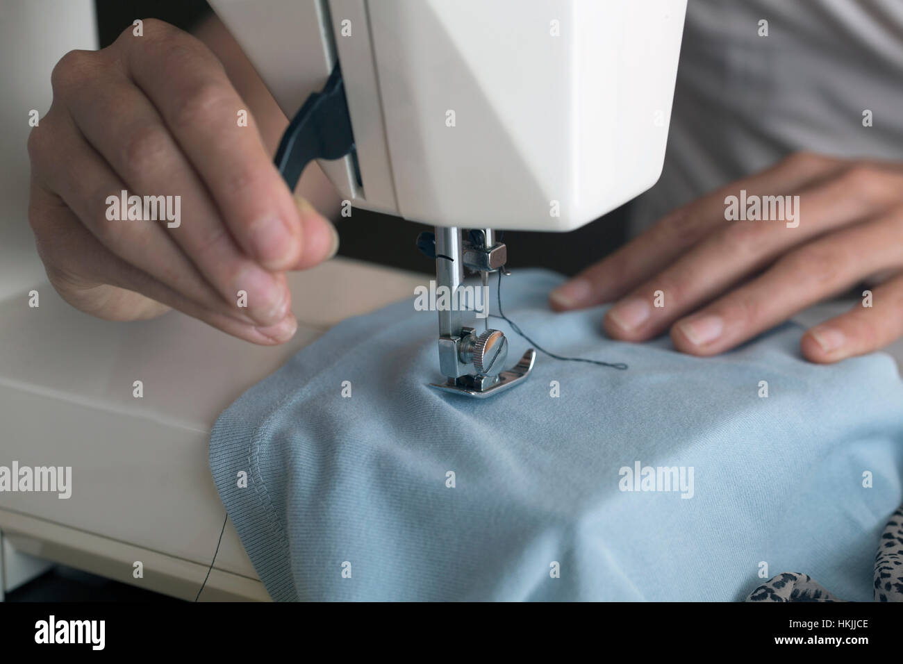 Female dressmaker stitching cloth on sewing machine, Freiburg im ...