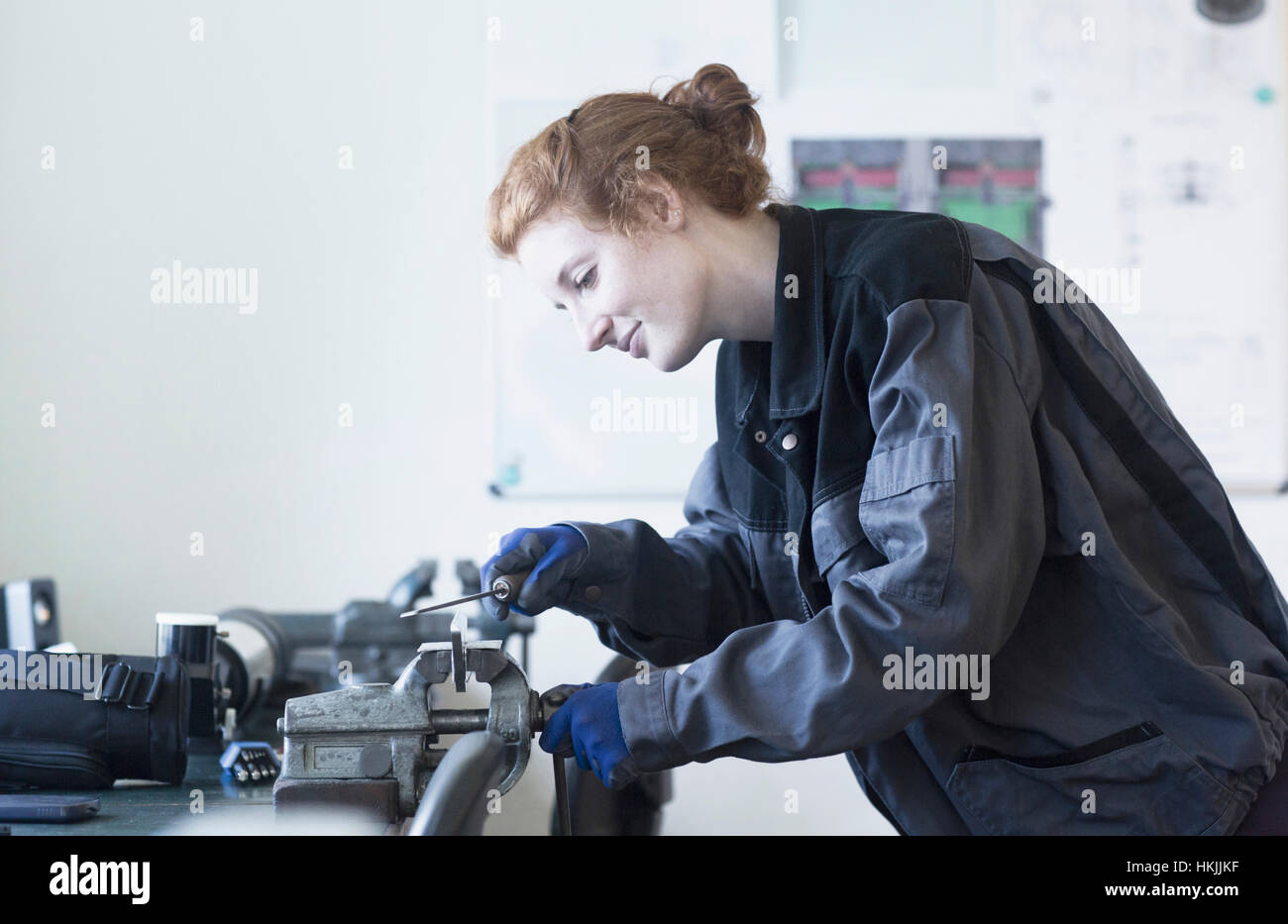 Young female engineer using vise grip tool in an industrial plant ...