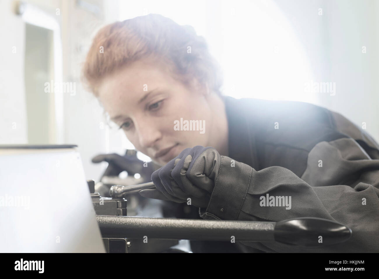 Female engineer in workshop with a lever in hand, Freiburg im Breisgau ...