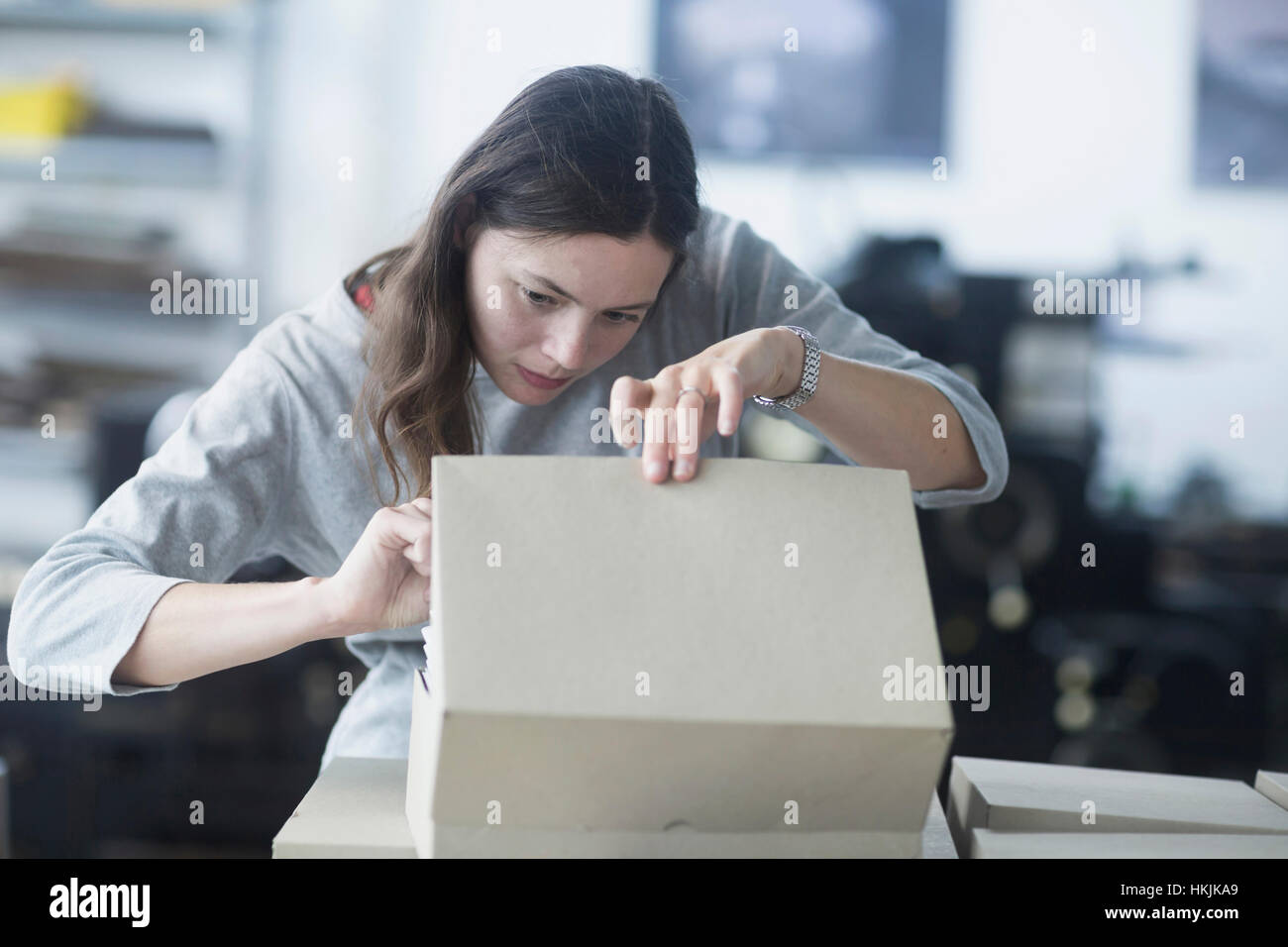 Print worker packaging cardboard box in an industry, Freiburg im ...
