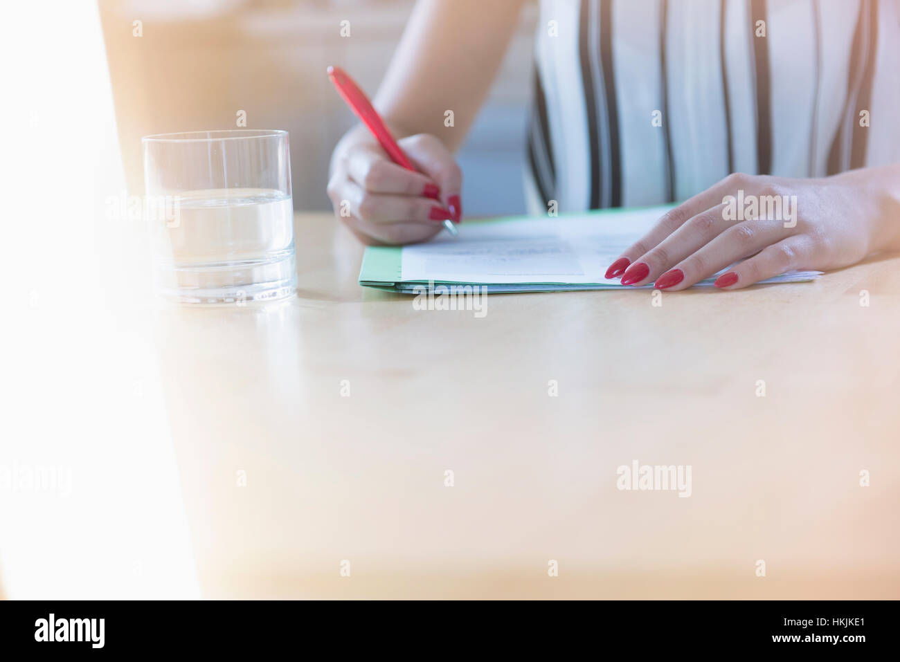 Woman signing paperwork hi-res stock photography and images - Alamy