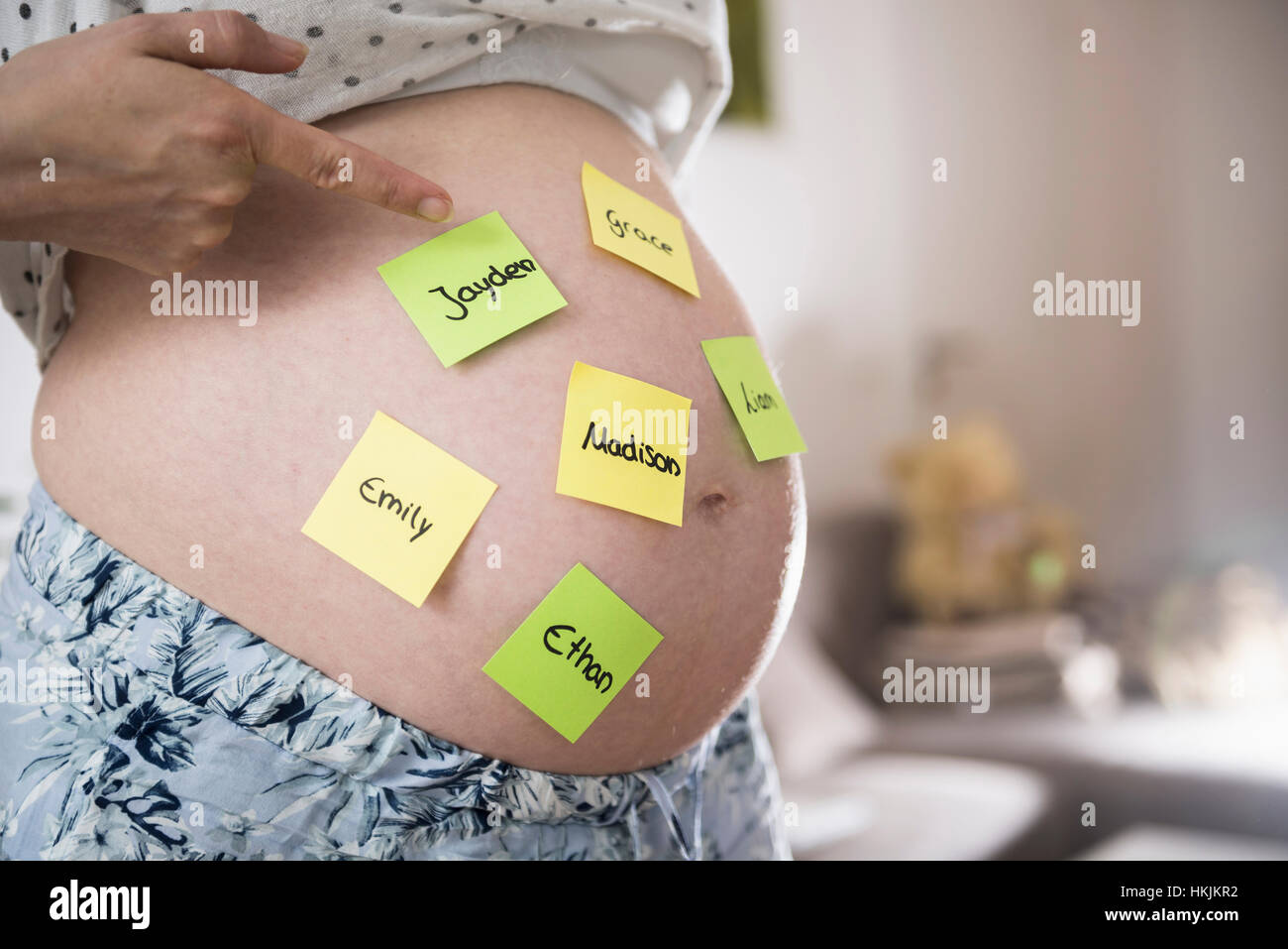 Pregnant woman with baby names on belly, Munich, Bavaria, Germany Stock ...