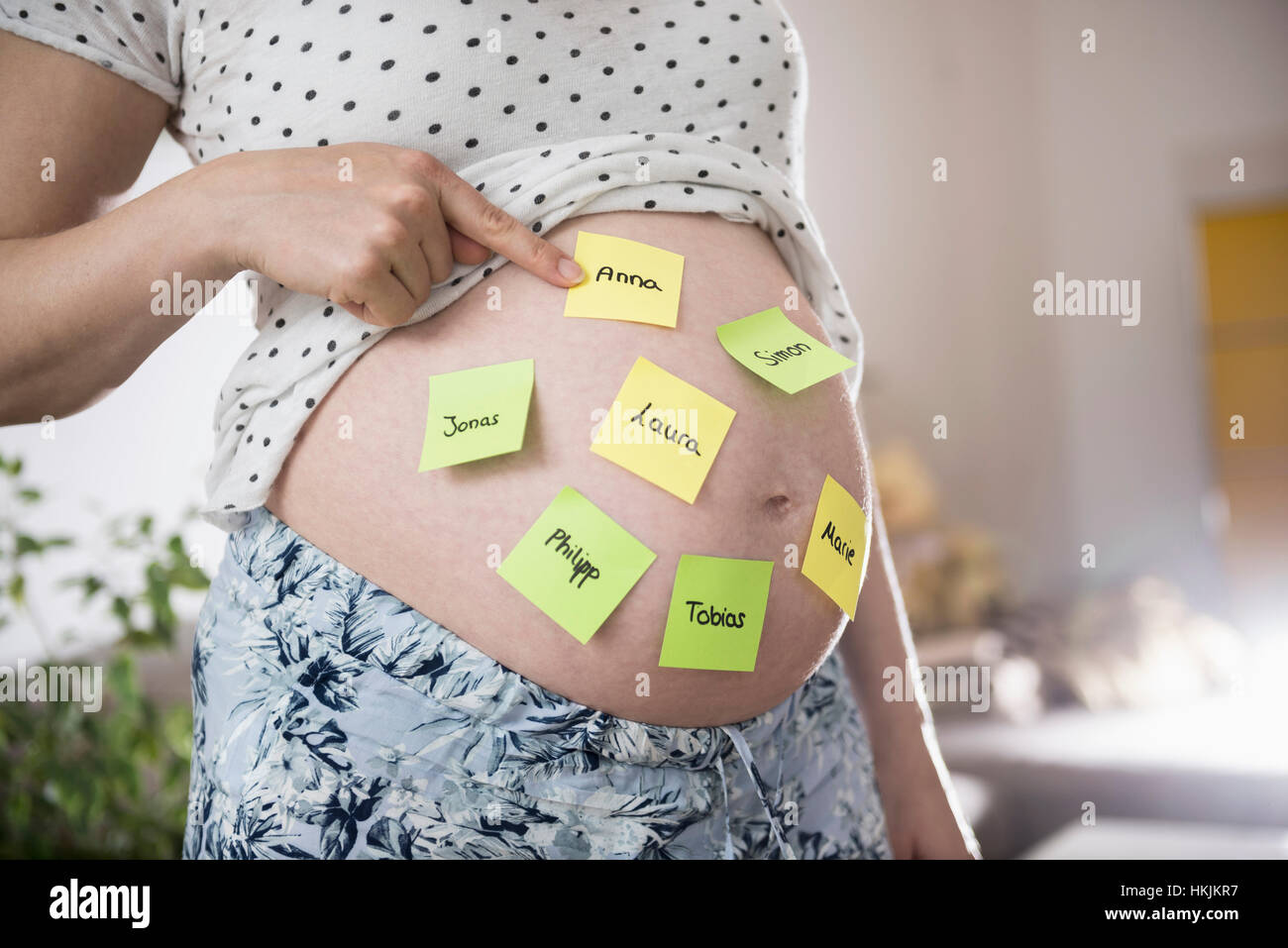 Pregnant woman with baby names on belly, Munich, Bavaria, Germany Stock ...