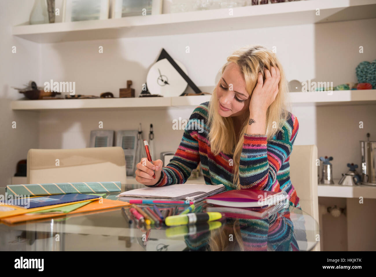 Young student doing homework in the living room, Bavaria, Germany Stock ...