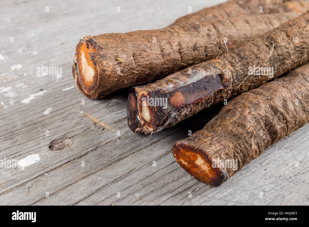 Group of black raw salsifies on wood Stock Photo - Alamy