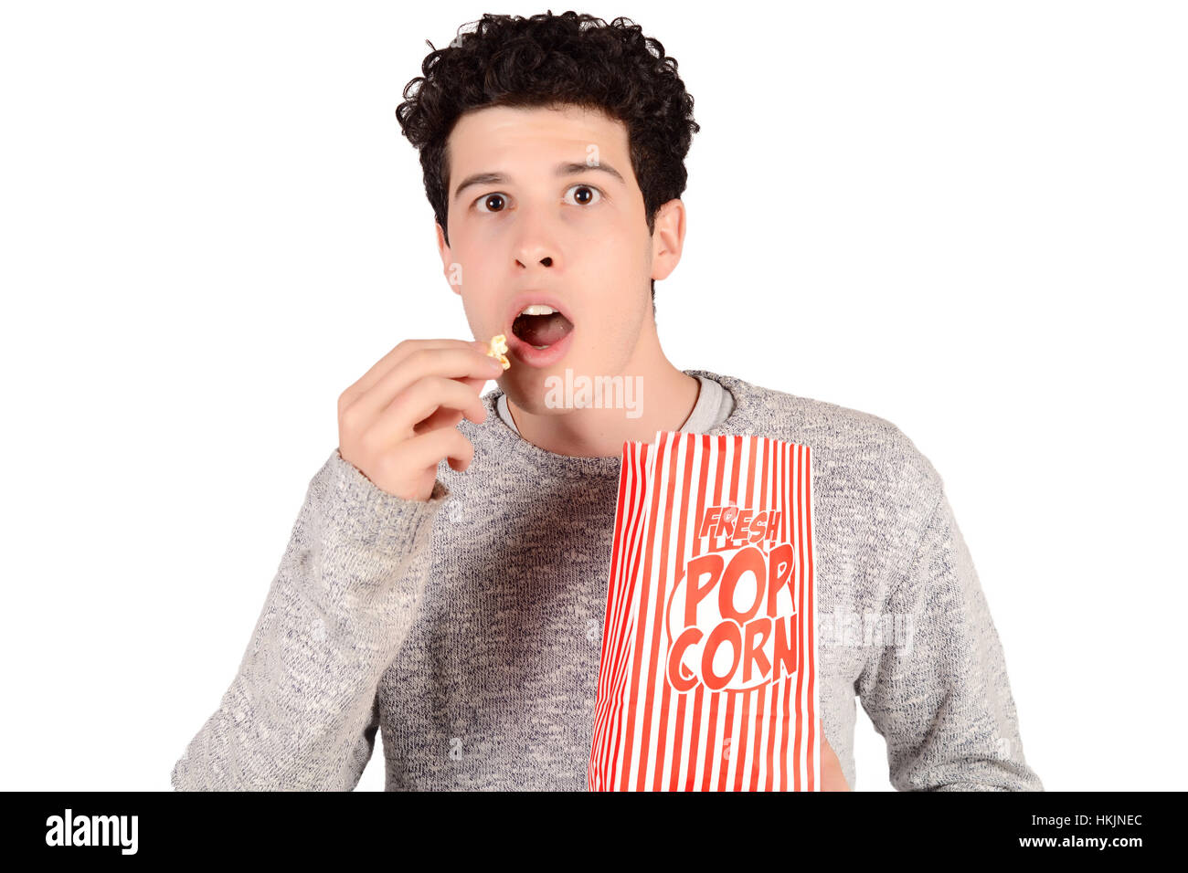 Portrait of young man eating popcorn. Isolated white background Stock ...