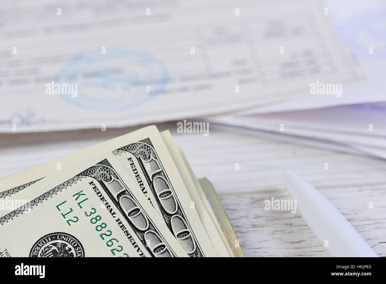 pay money bills with dolars on wood table Stock Photo - Alamy