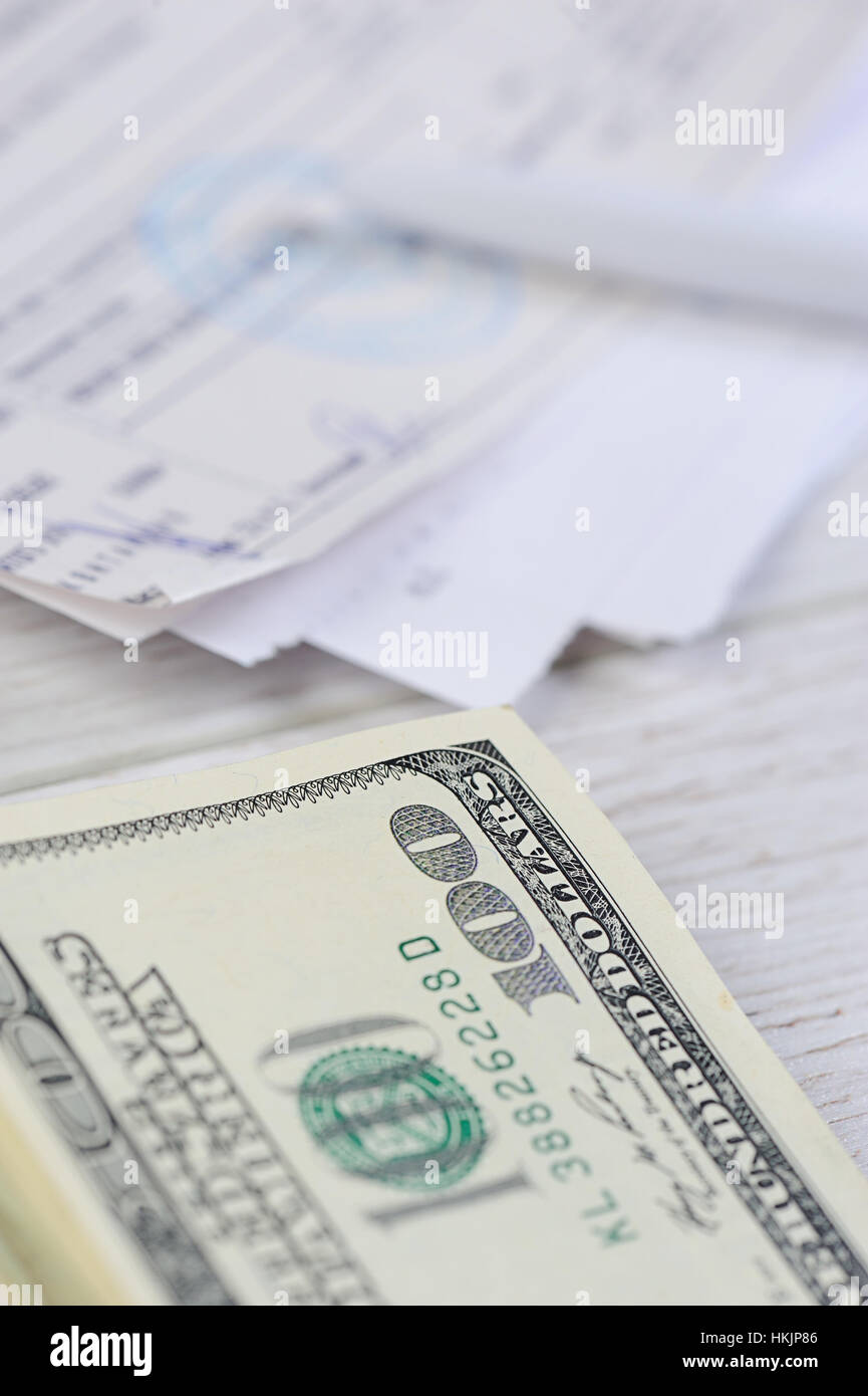 pay paper bills with dollars on wood table Stock Photo - Alamy