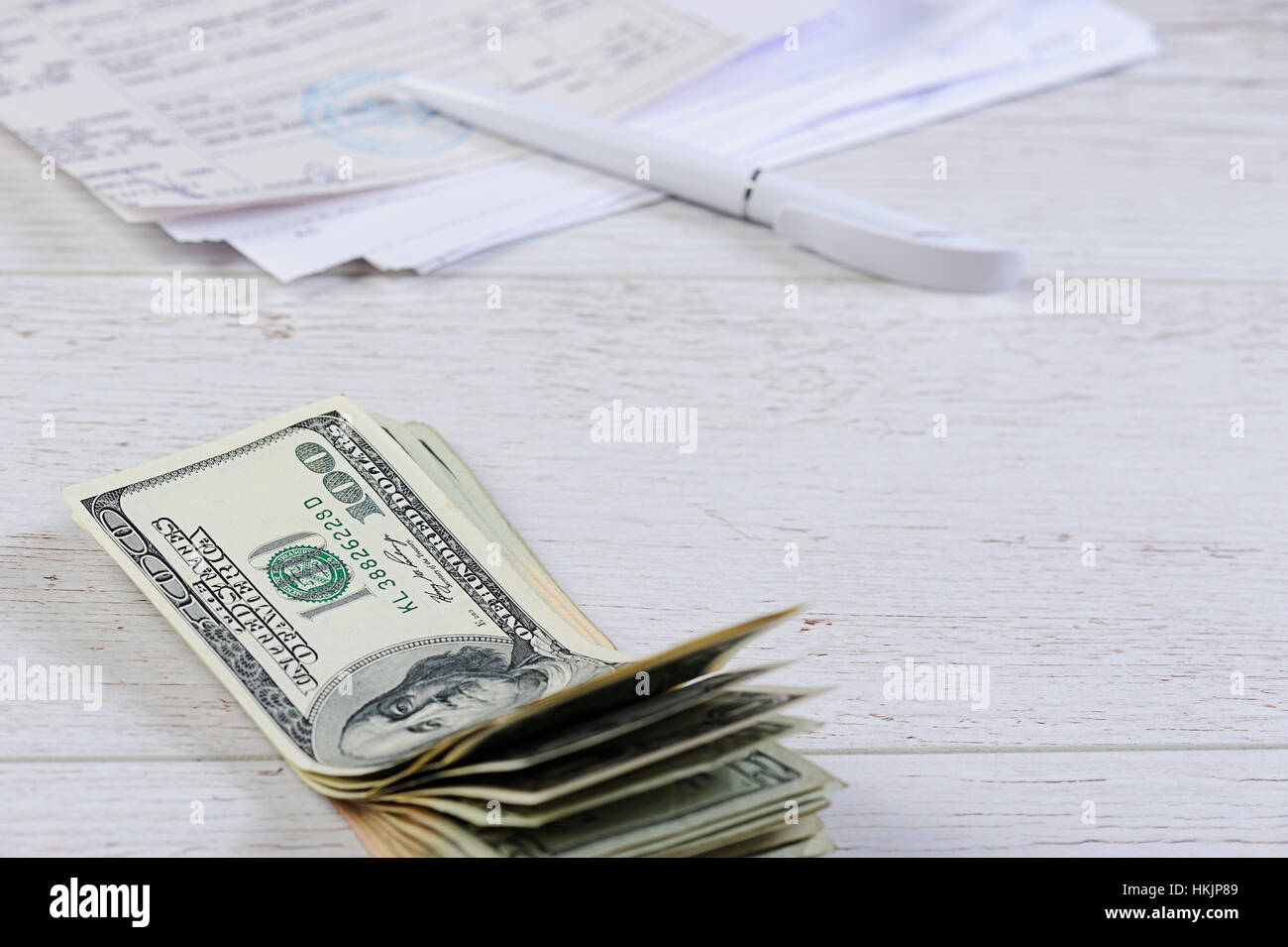 count and pay bills with money on wood table Stock Photo - Alamy