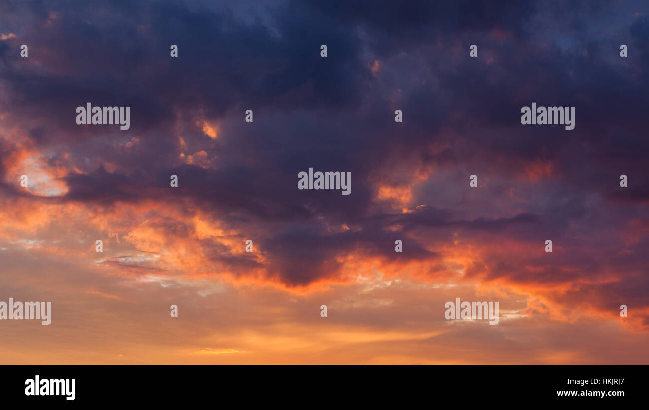 Fiery vivid sunset sky clouds Stock Photo - Alamy