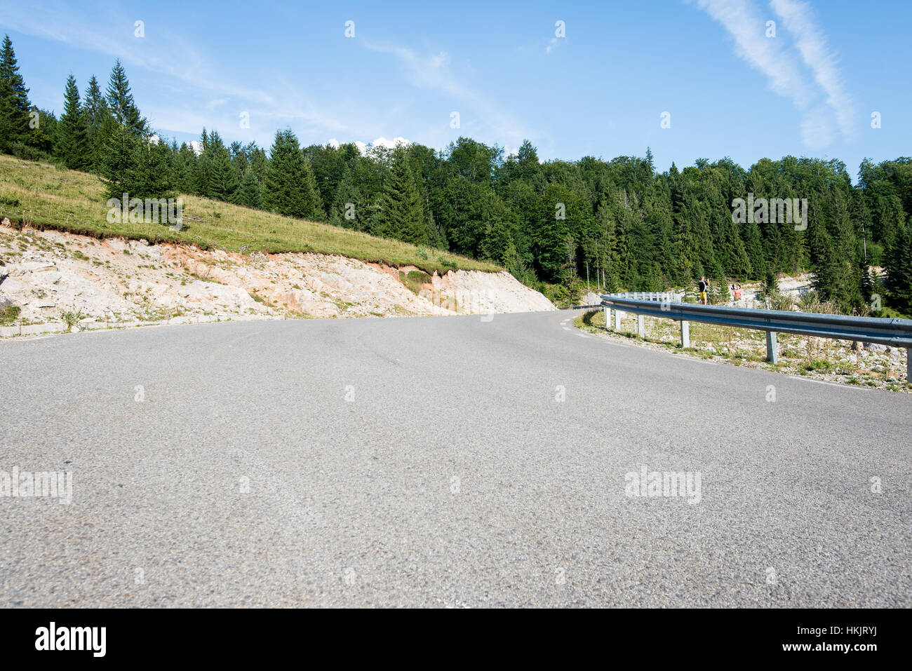 Winding country Road with clouds above and dry tarmac Stock Photo - Alamy