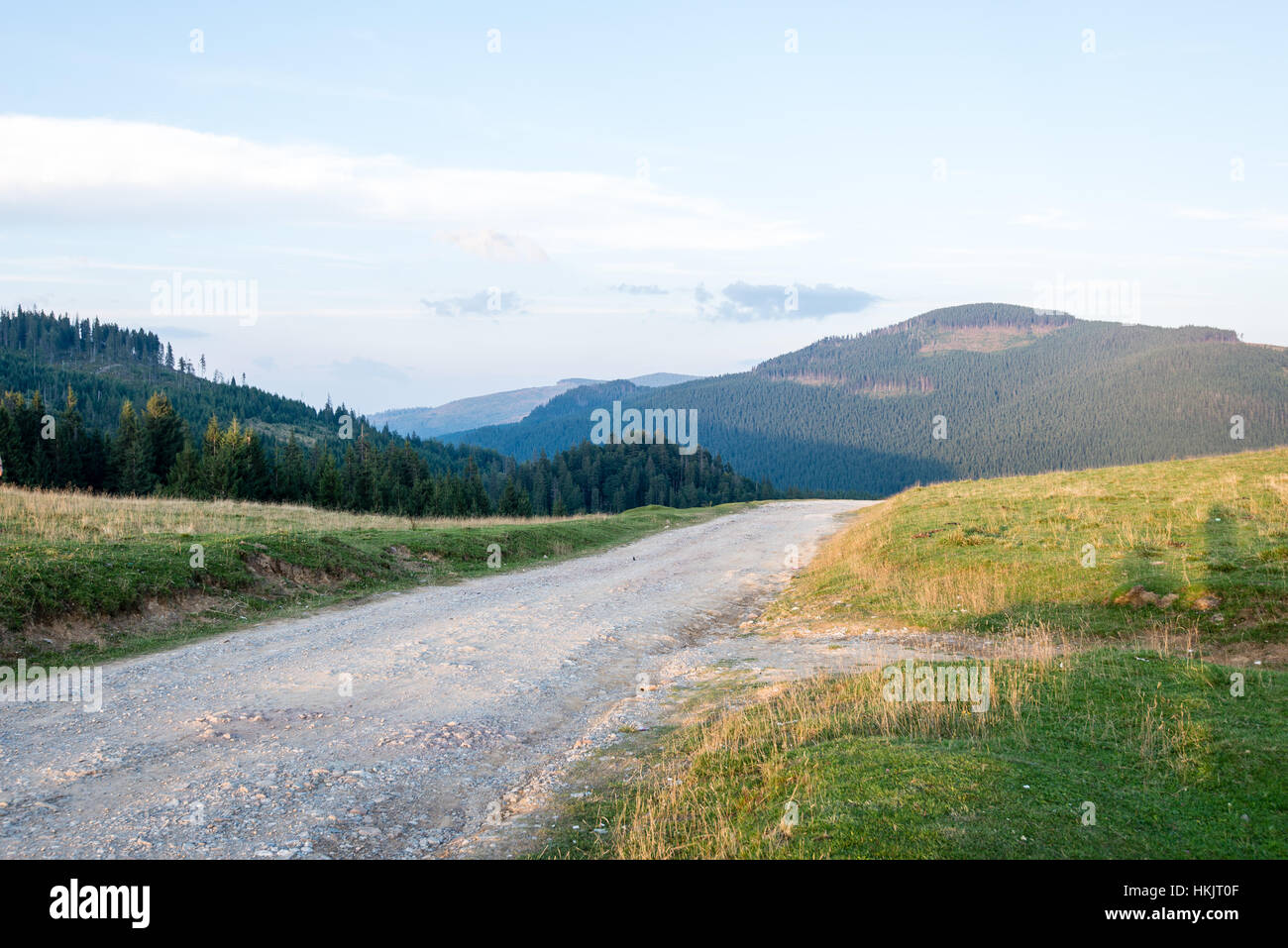 Winding country Road with clouds above and dry tarmac Stock Photo - Alamy