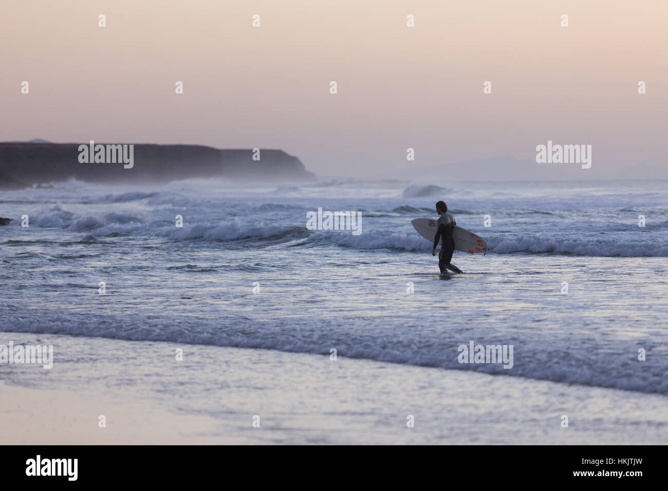 Surfers on beach with surfboard Stock Photo - Alamy