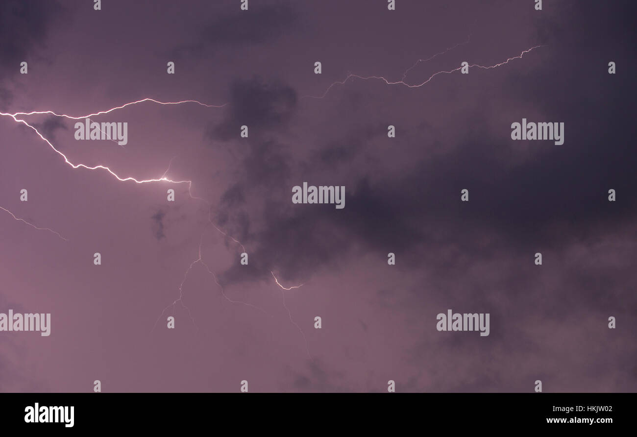 Lightning strike horizontal in the sky at night with clouds Stock Photo ...