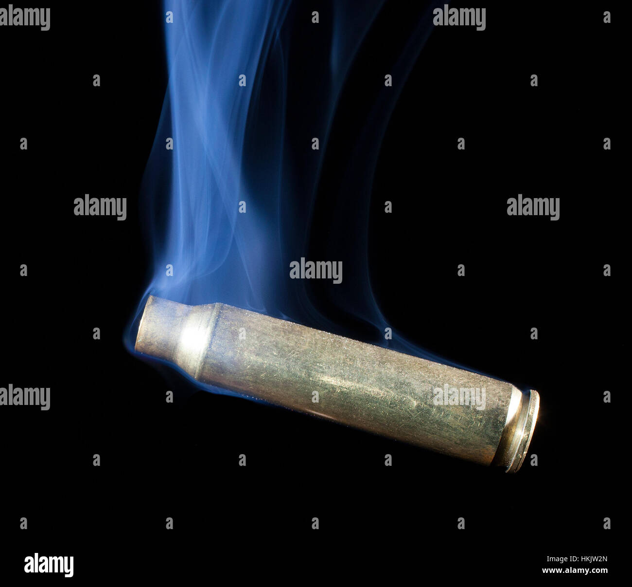 Casing from a rifle cartridge that has been shot and is smoking Stock ...