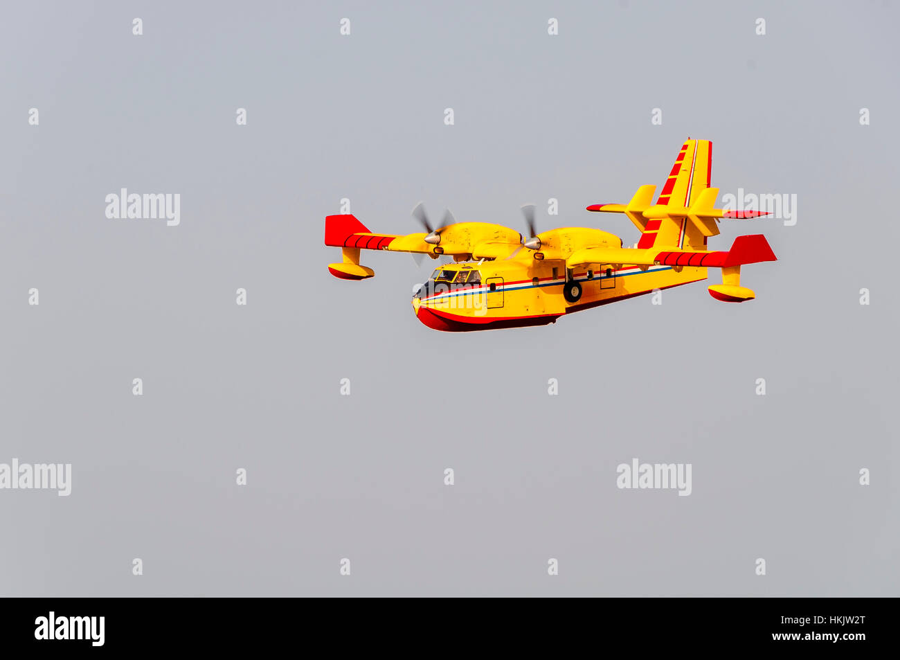 Yellow and red Canadair water bomber, turbo prop firefighting aircraft ...