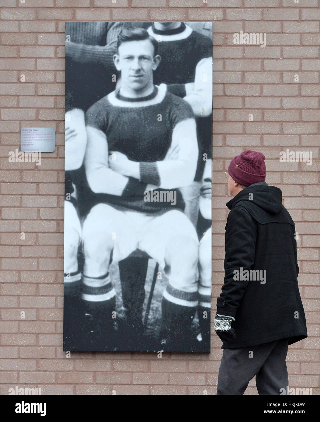 A Burnley fan looks at a poster of George Beel before the Emirates FA ...