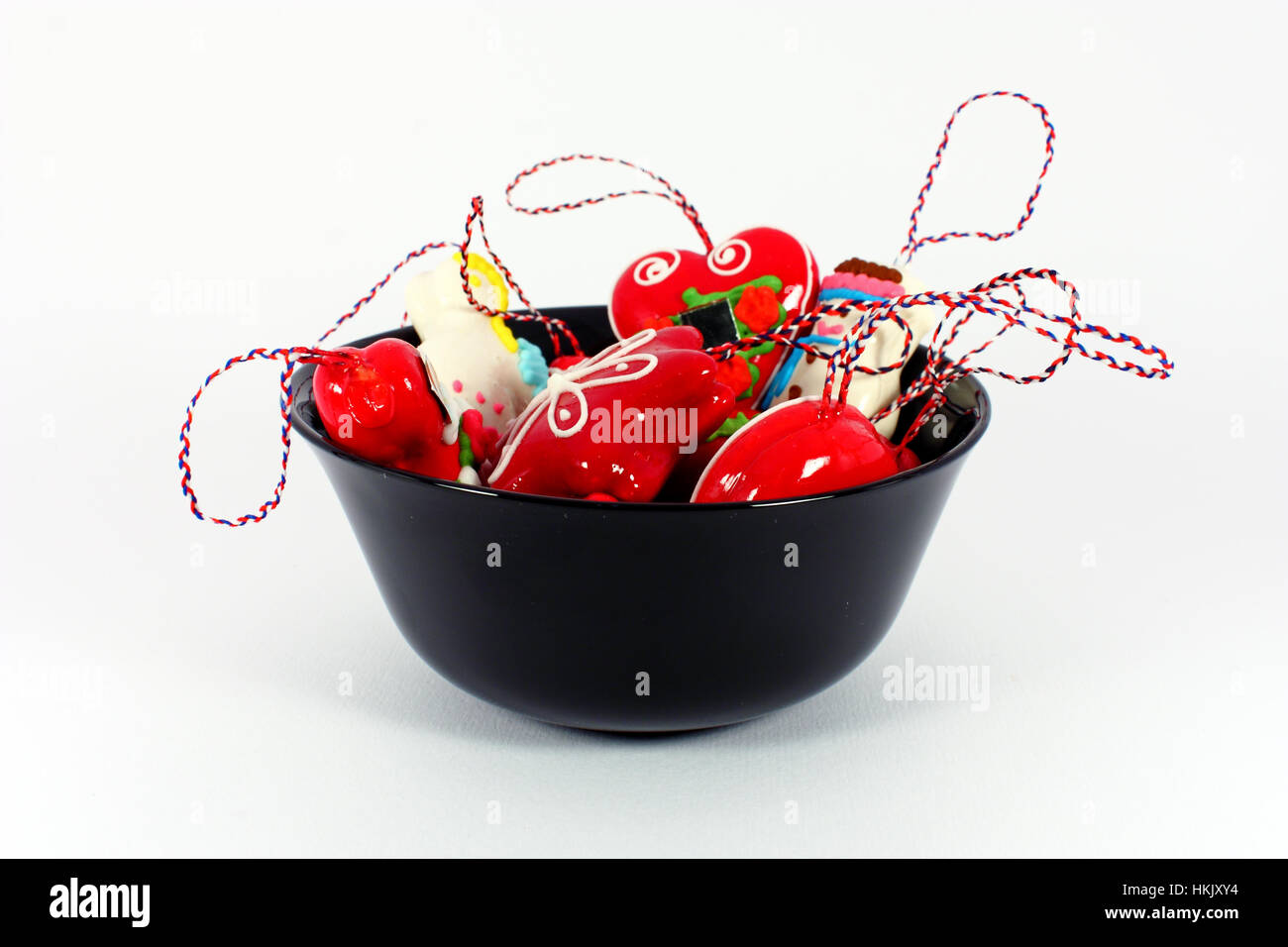 Little Licitar cookies in black bowl isolated on white Stock Photo - Alamy