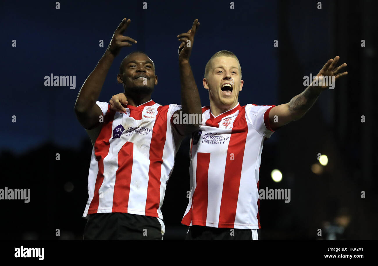Lincoln's Theo Robinson (left) celebrates scoring his sides third goal ...