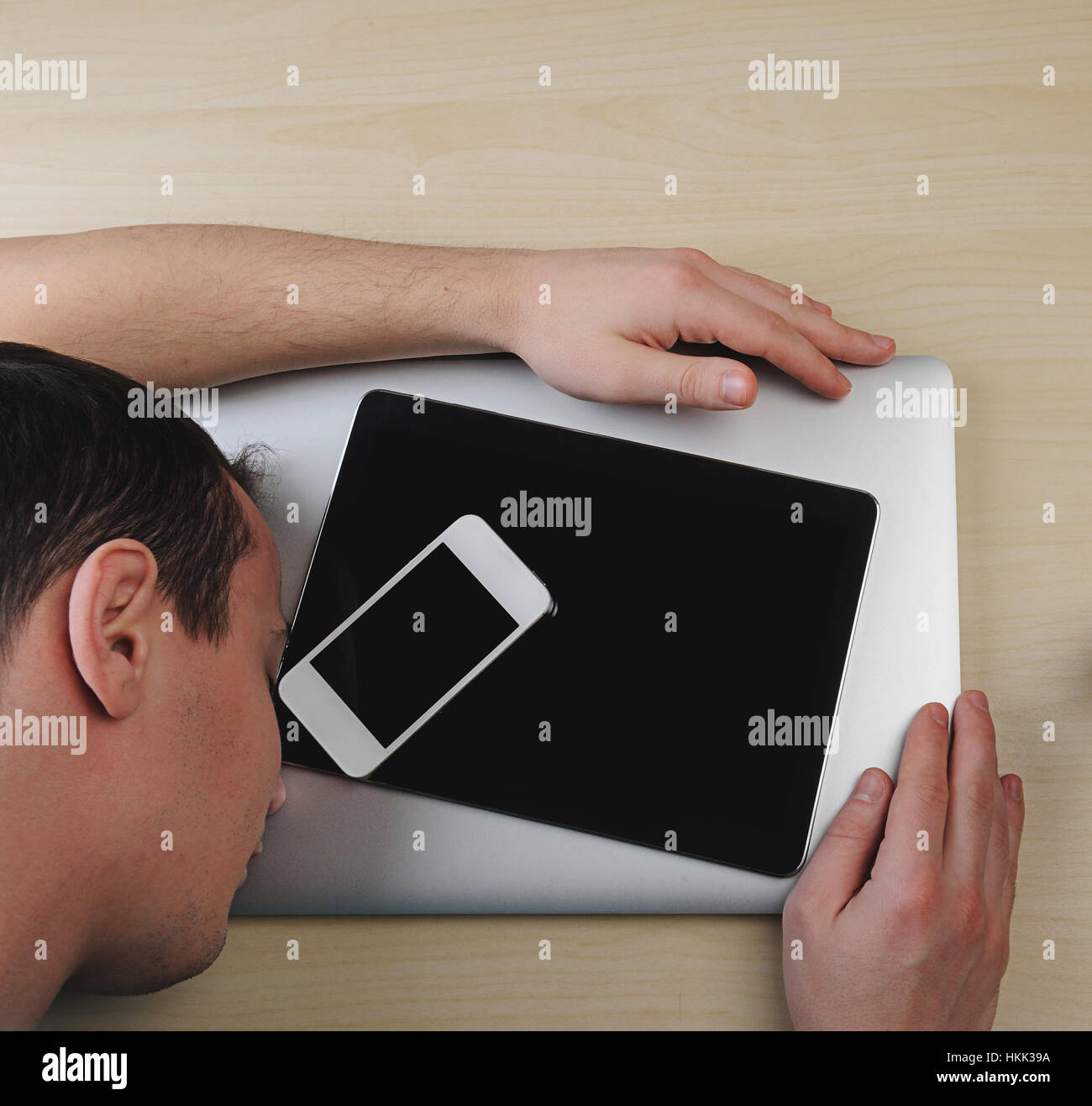 Guy sleeping and give hug to laptop on wood table Stock Photo - Alamy