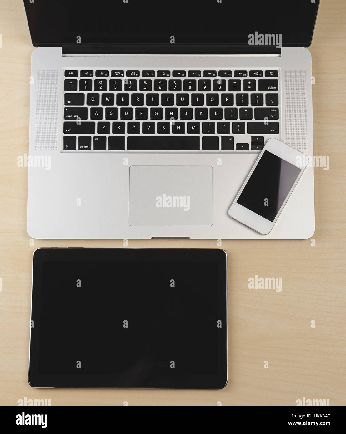 Modern mobile devices on top of wooden table Stock Photo - Alamy